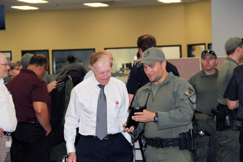 Aurora Police Chief thanks Alarm Detection Systems for donation of ...